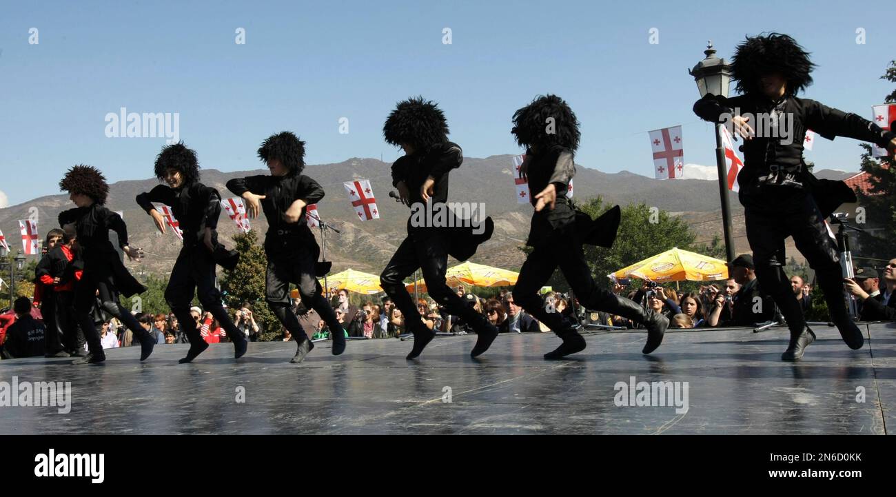 Young Georgians dressed in traditional costumes dance in Mtskheta, some ...
