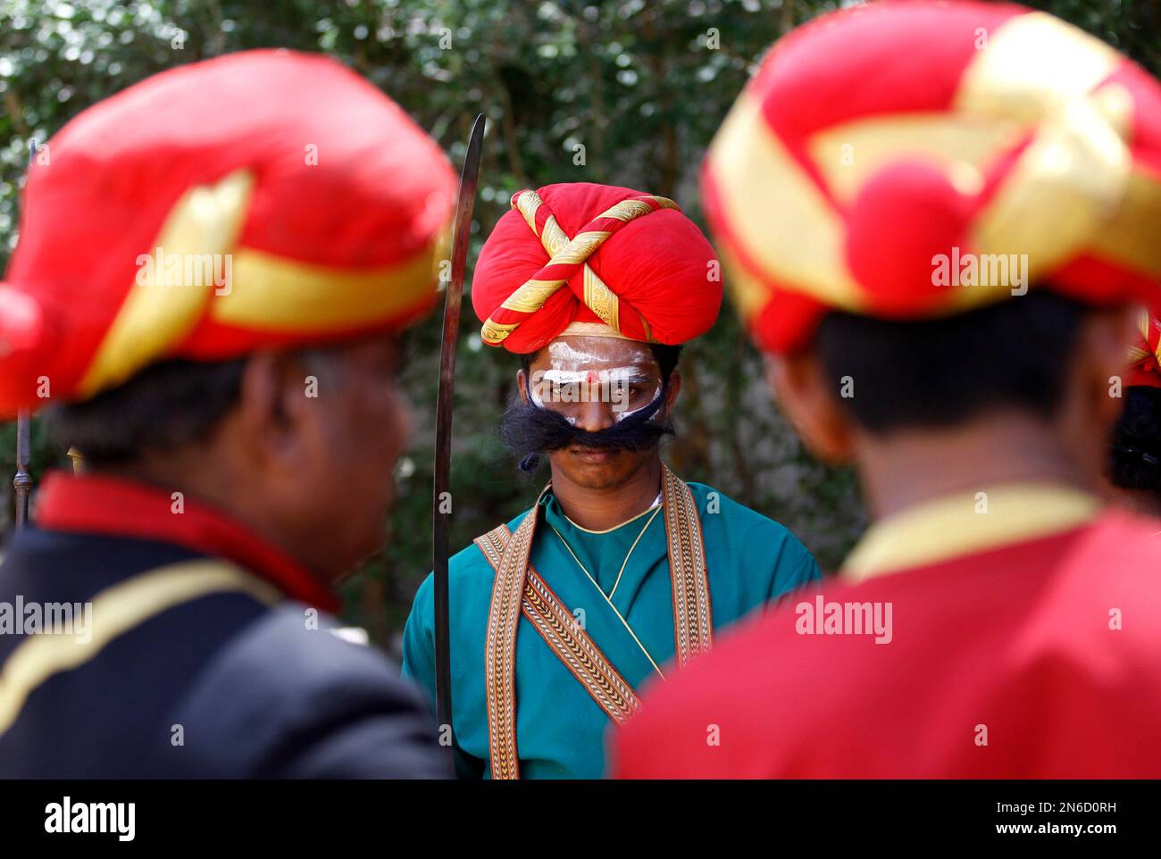 A man dressed as a guard of the erstwhile Mysore royal kingdom holds a ...