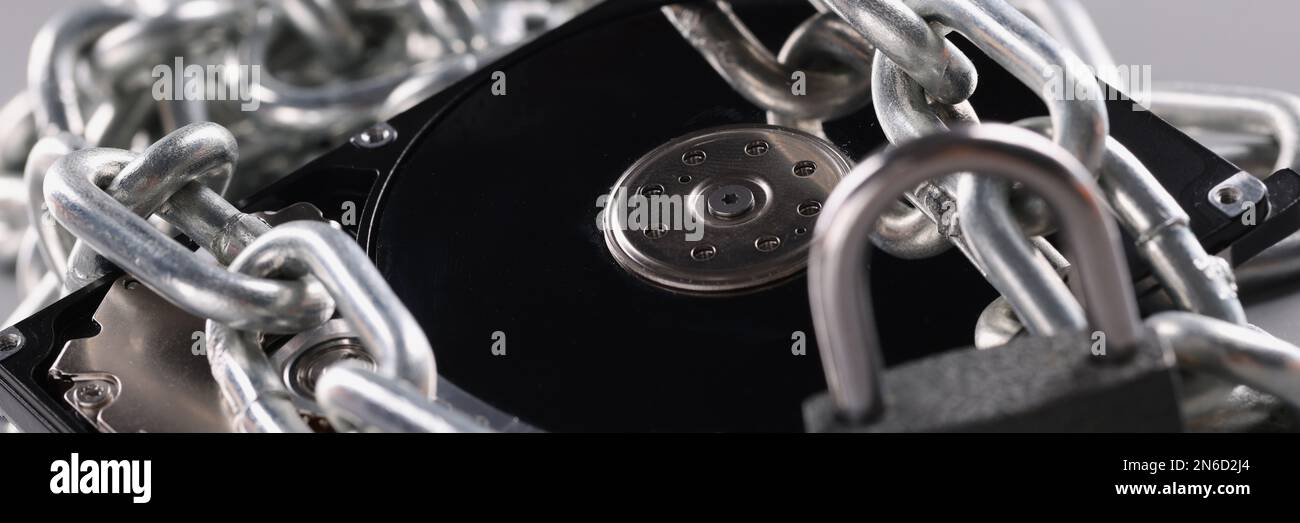 Computer hard drive is wrapped in chain Stock Photo - Alamy