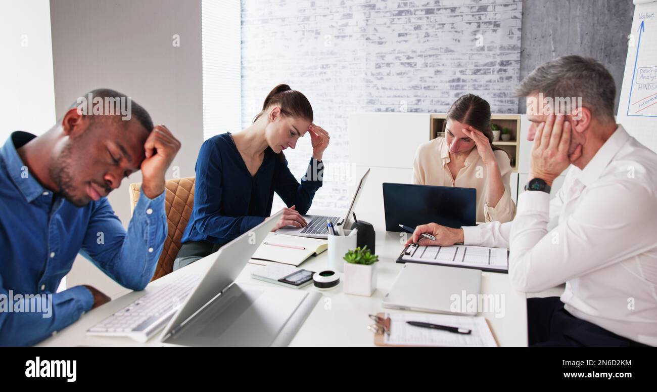Bored Male Manger Sitting With His Colleagues Giving Presentation In ...