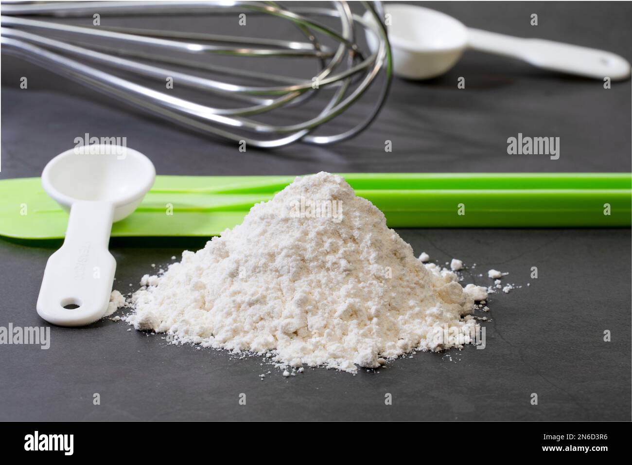 The pile of organic wheat flour bakery side view on dark background ...