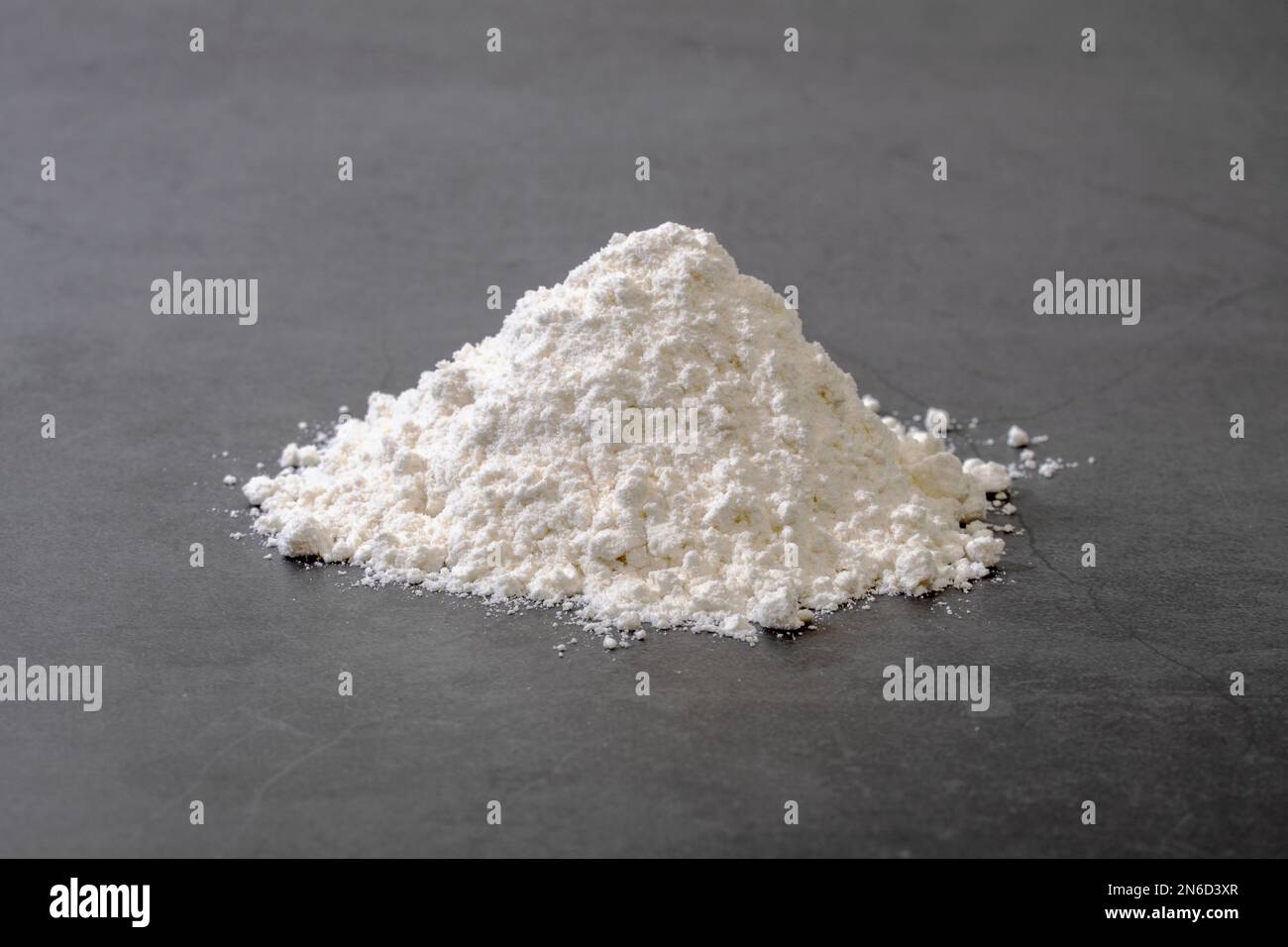 The pile of soft wheat flour side view on dark background Stock Photo ...