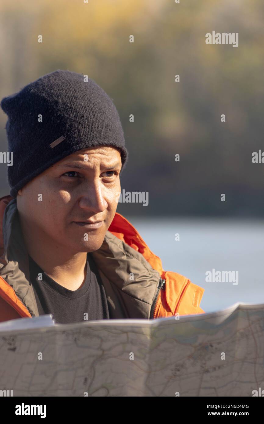 Portrait of traveler man at lake in autumn with a map Stock Photo - Alamy