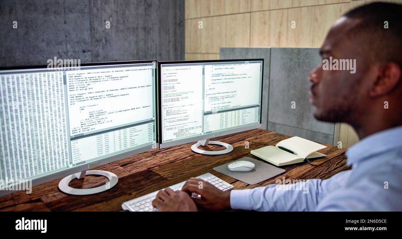 African American Coder Using Computer At Desk. Web Developer Stock ...