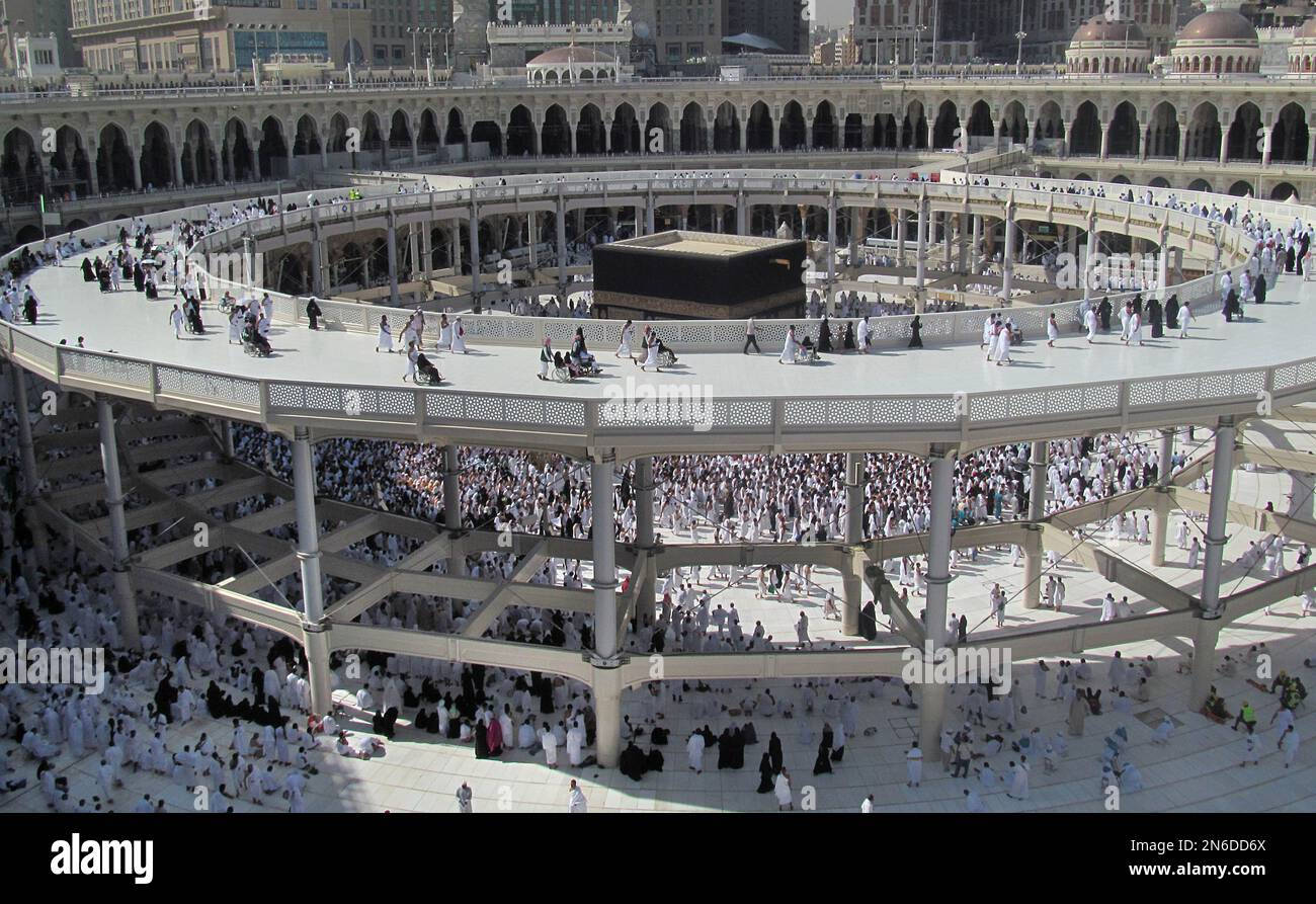 Muslims, some in wheelchairs circle the Kaaba, the cube-shaped ...