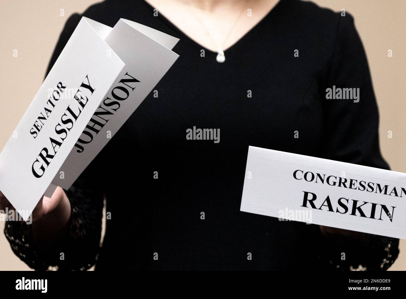 A staff member sets out name tags before a hearing on the Weaponization ...