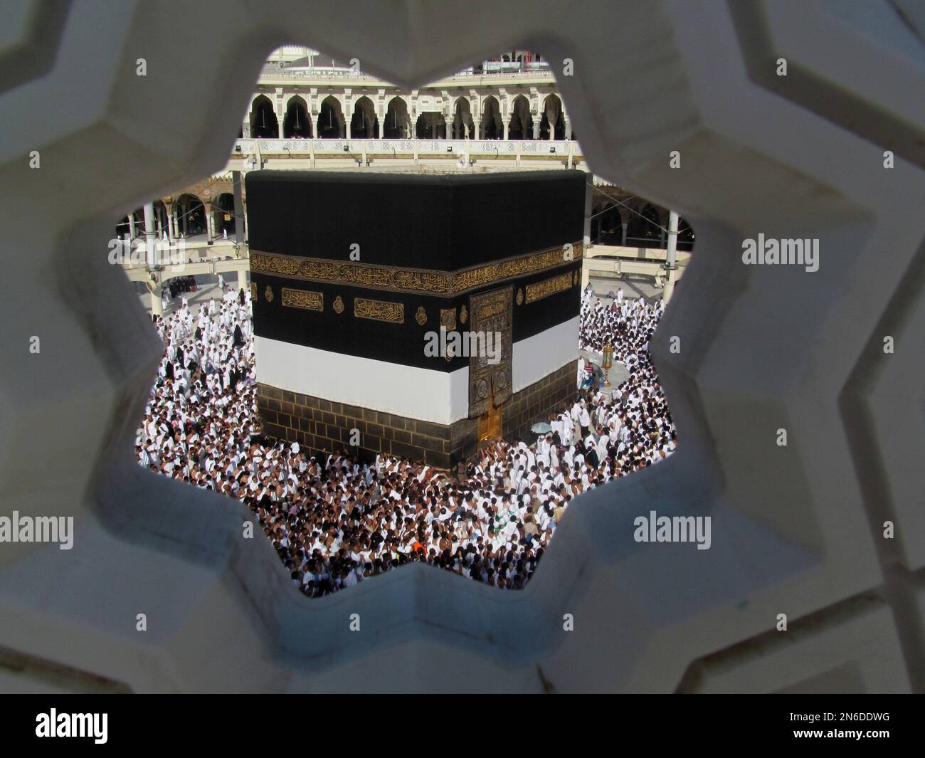 Muslim pilgrims are seen through a decorative window of the Grand ...