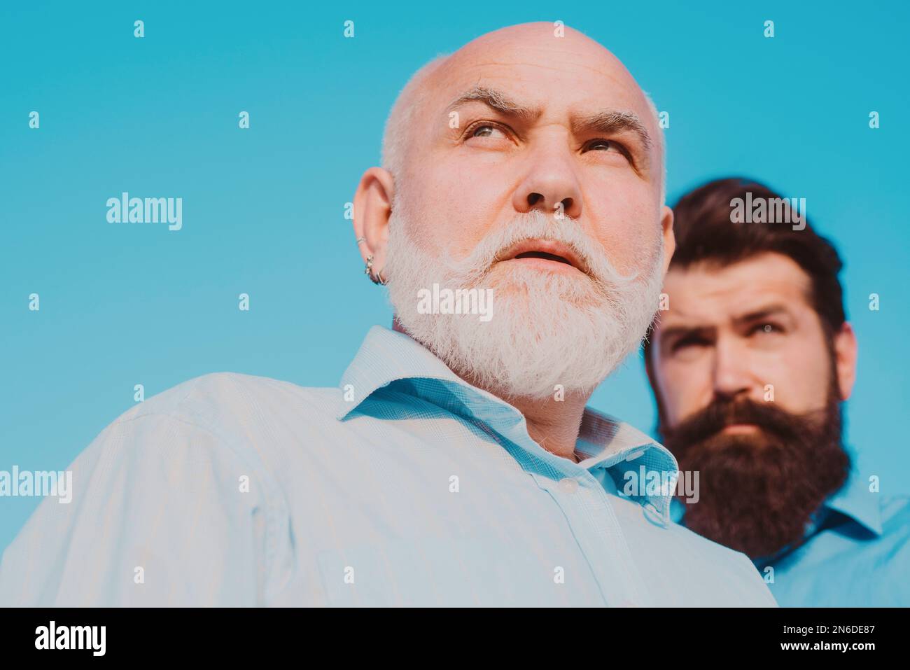 Two different generations ages: grandfather and father together ...