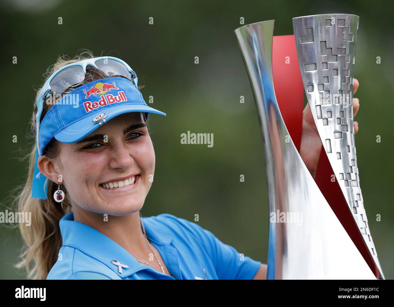 Lexi Thompson of the US holds her trophy aloft after winning the ...