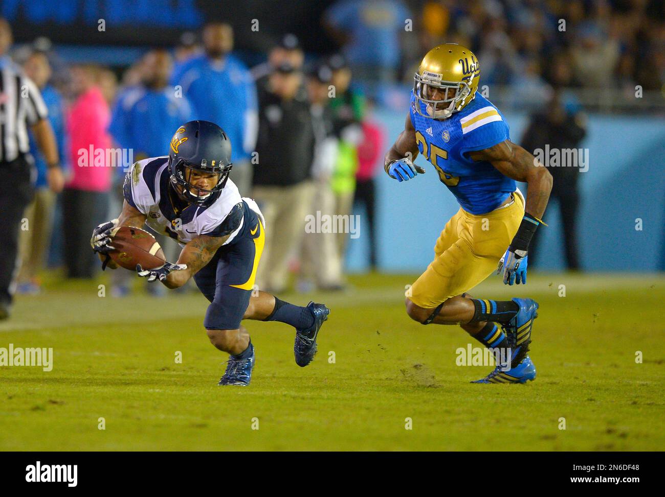 California wide receiver Bryce Treggs, left, catches a pass as UCLA ...