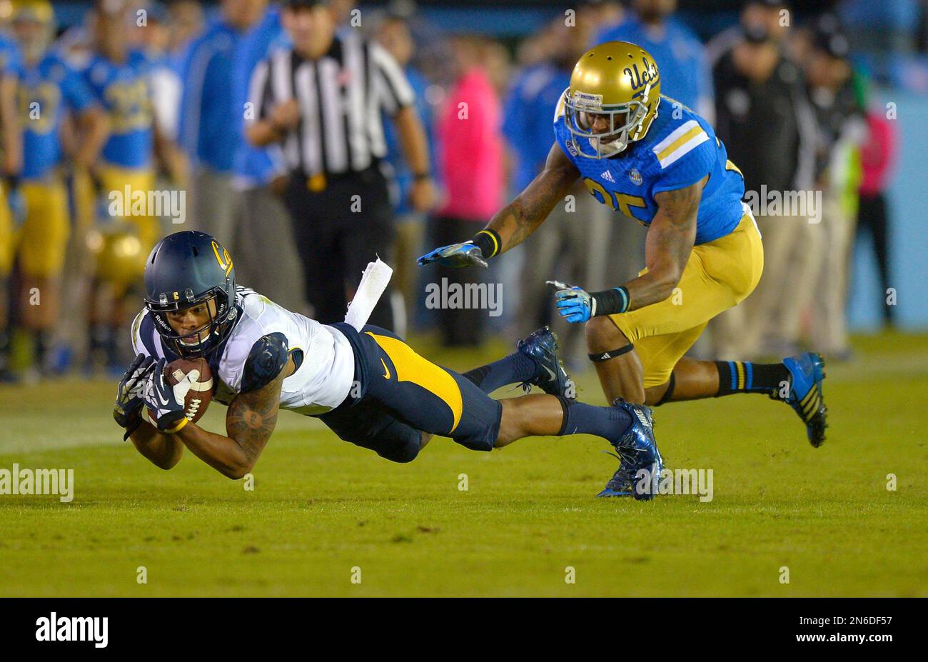 California wide receiver Bryce Treggs, left, catches a pass as UCLA ...