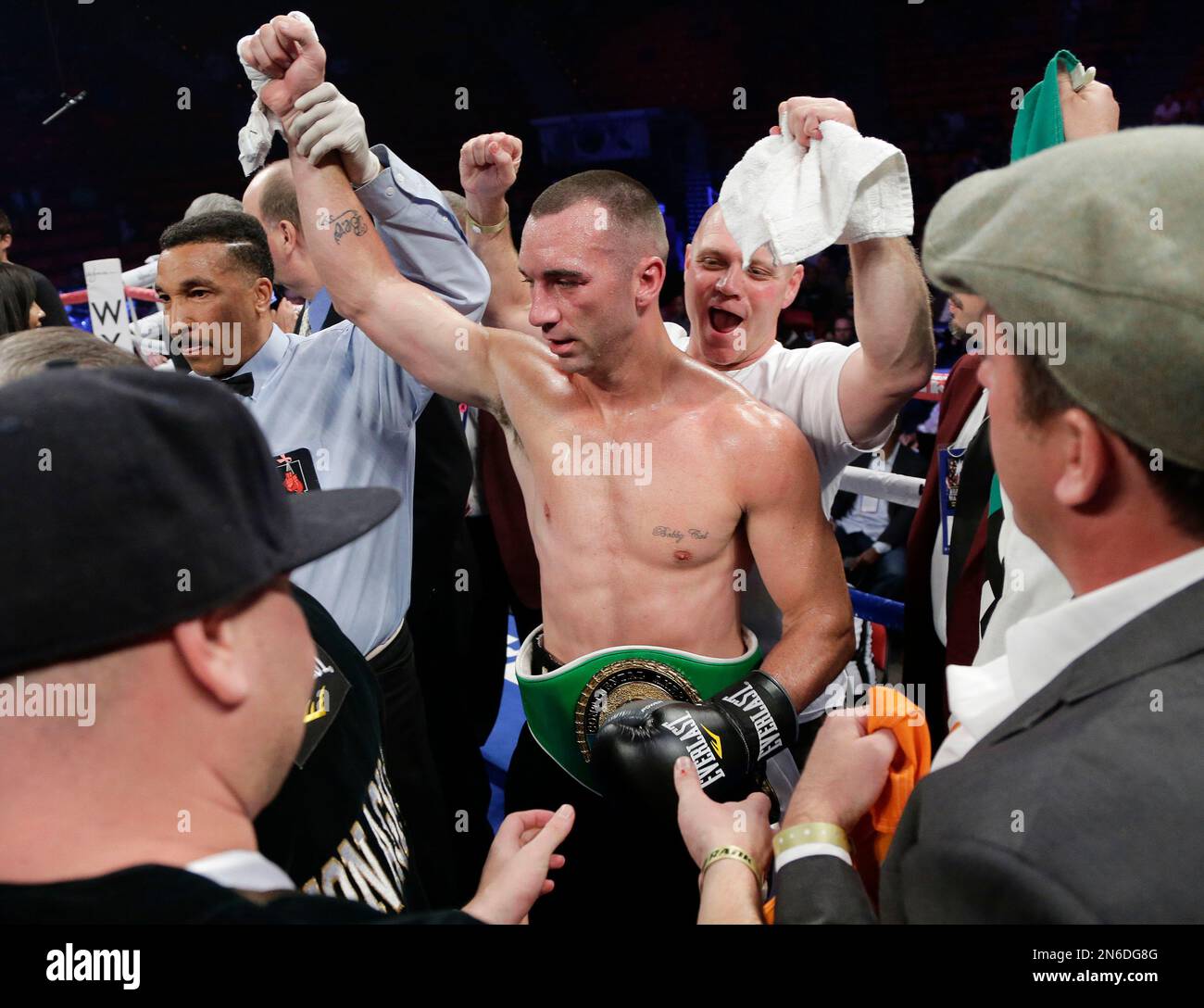 Sean Monaghan, center, is declared the winner by referee Tony Weeks ...