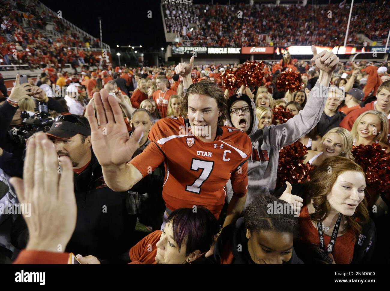 Utah quarterback Travis Wilson (7) receives high-fives a fan after Utah ...