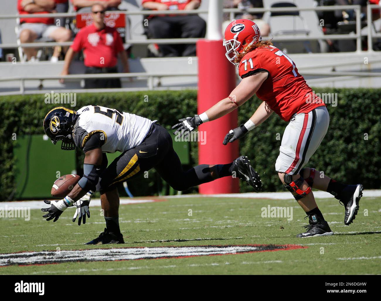 Missouri defensive lineman Michael Sam (52) scoops up a fumble in front ...