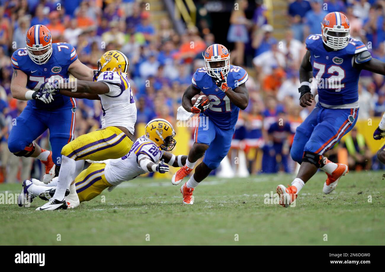 Florida running back Kelvin Taylor (21) carries past Florida linebacker ...