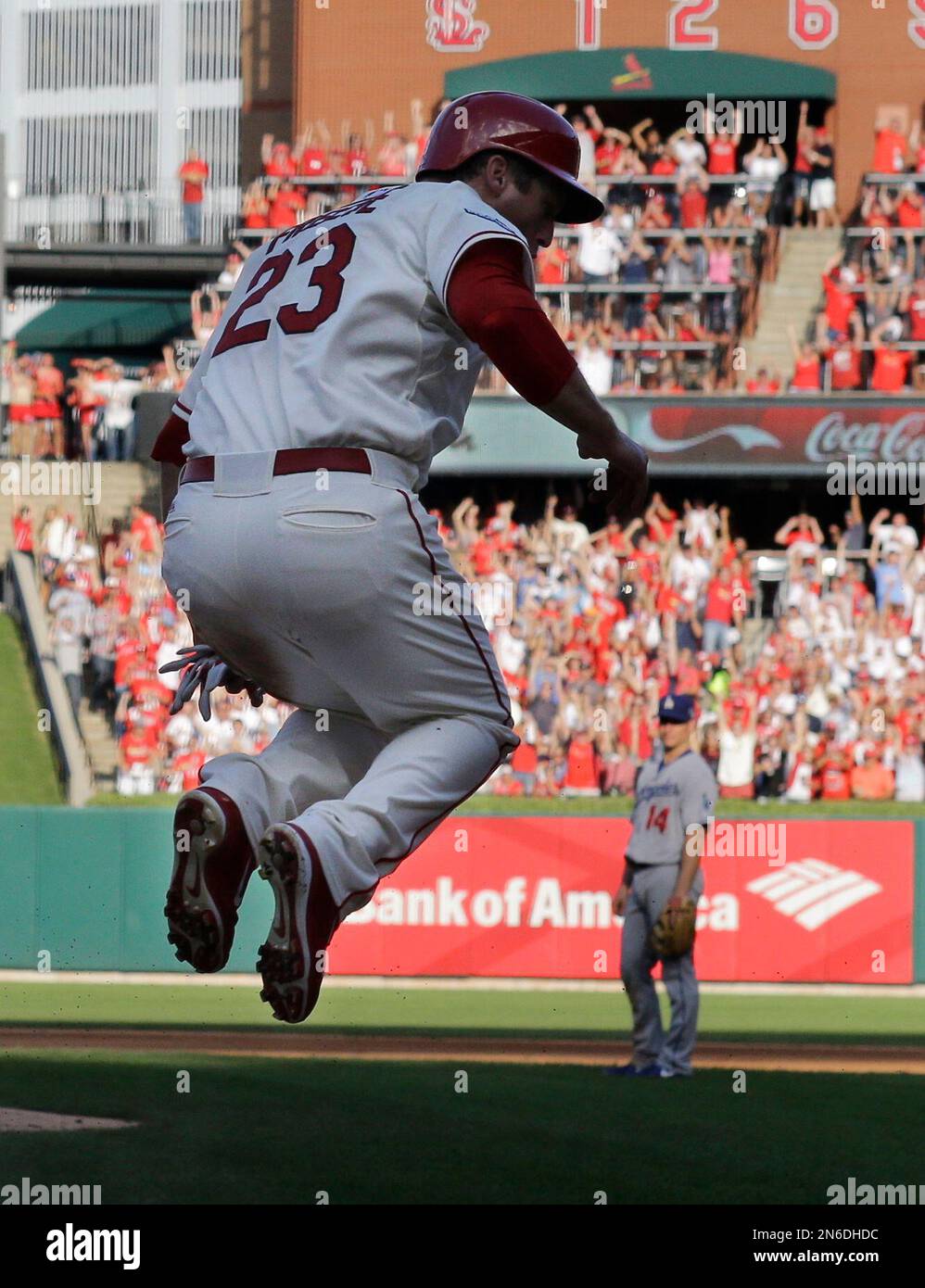 St. Louis Cardinals' David Freese jumps over home plate after scoring ...