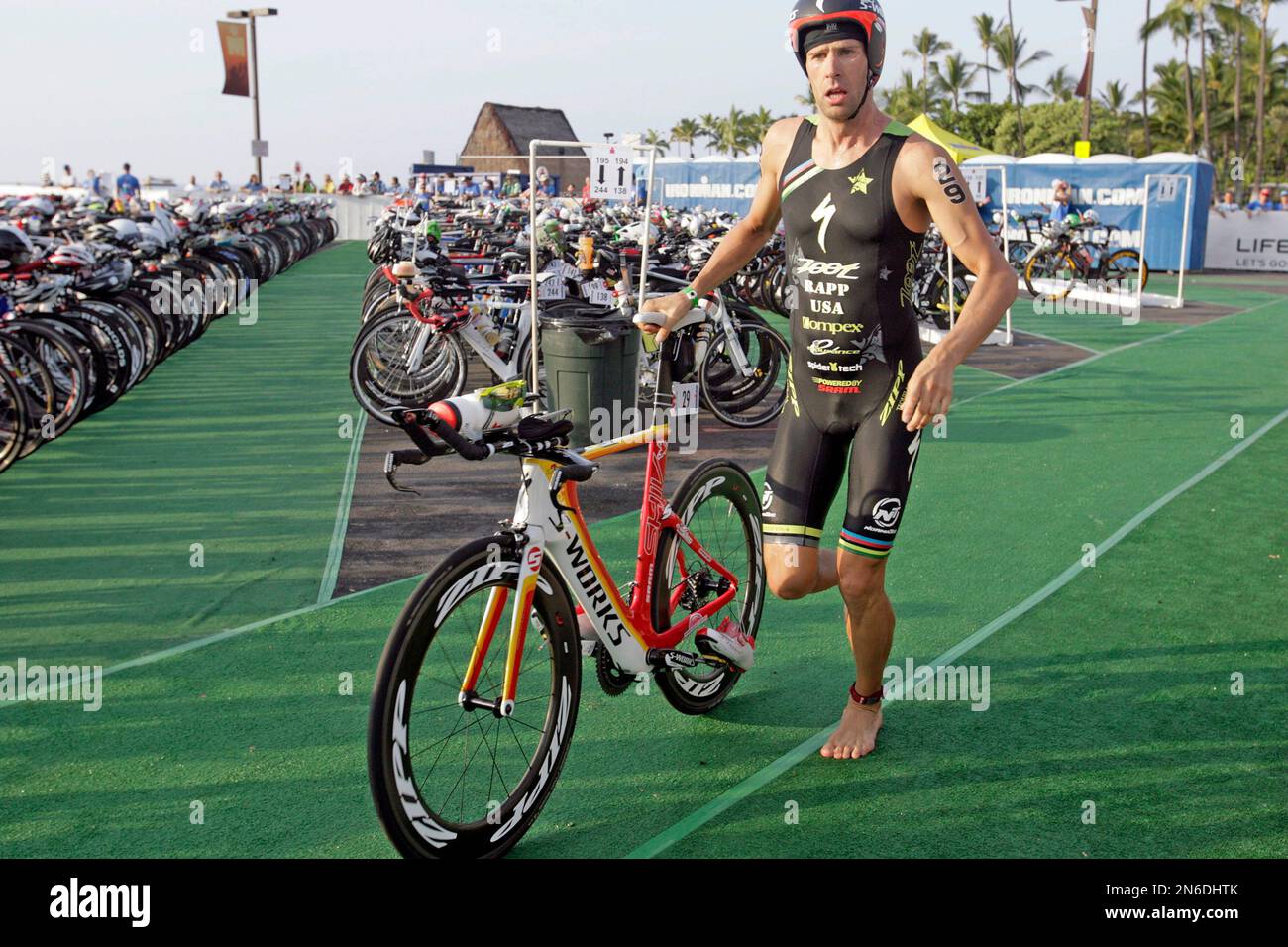 Competitor Jordan Rapp, of the United States, runs with his bicycle on ...