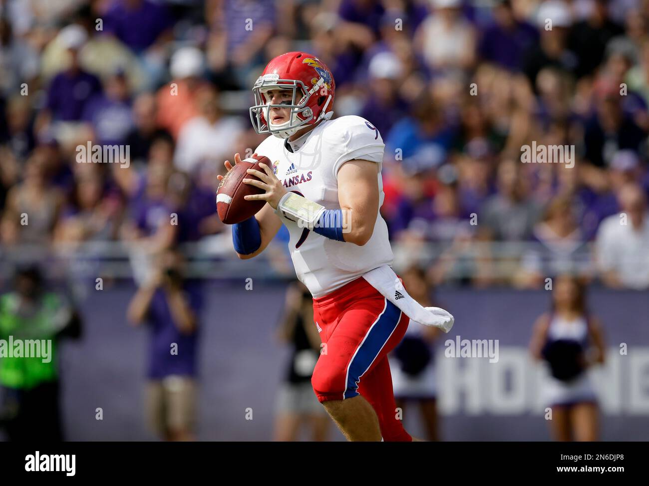 Kansas quarterback Jake Heaps (9) scrambles out of the pocket before ...