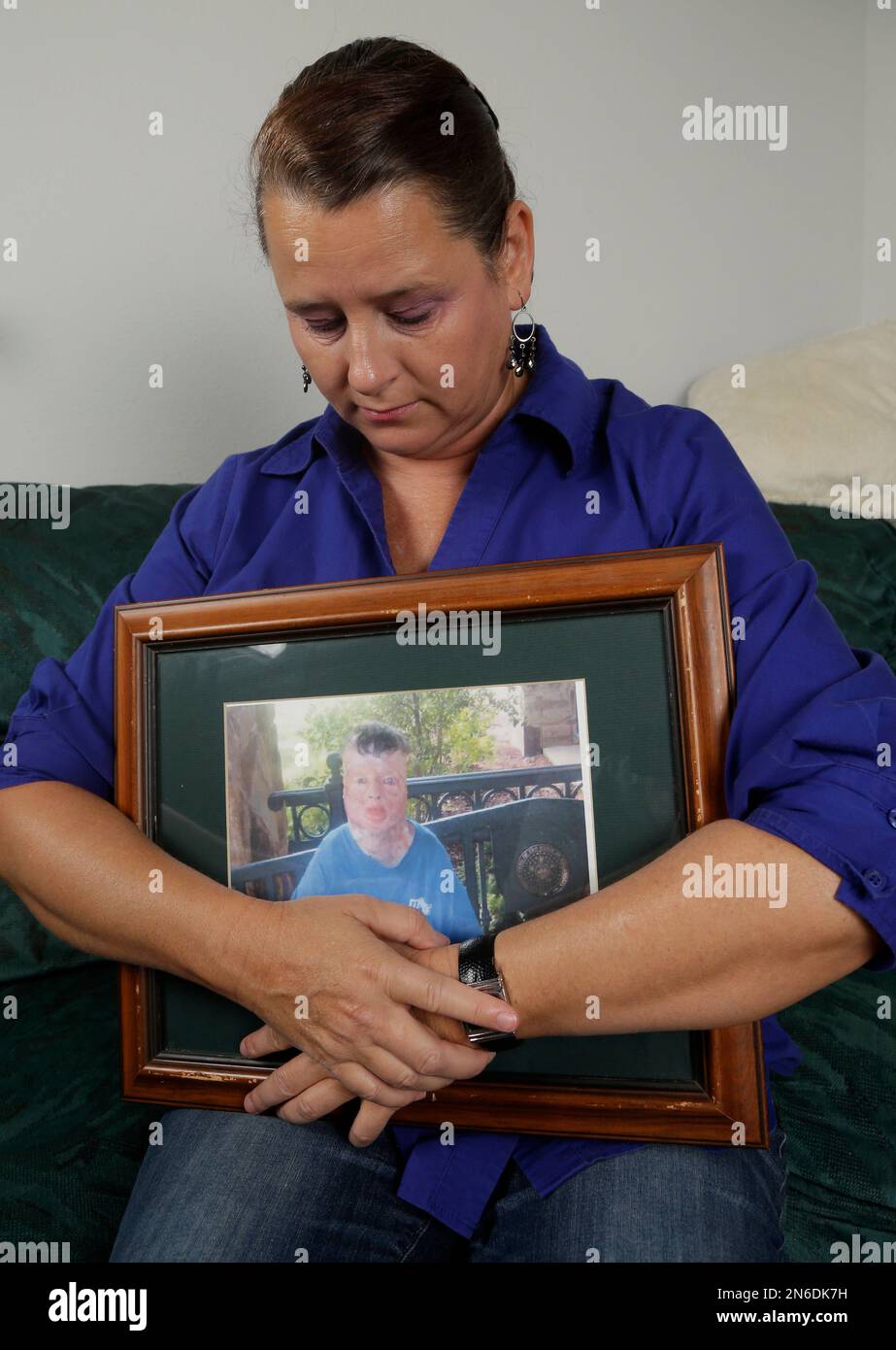 Colleen Middleton holds a photograph of her son, Robert, after an ...