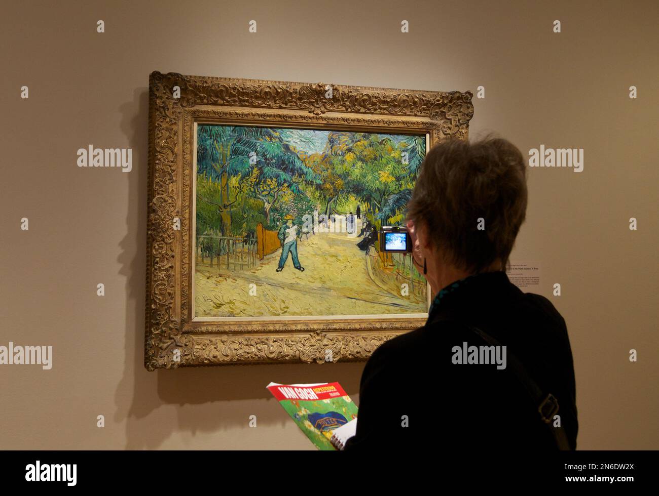 A woman photographs Vincent van Gogh's "Entrance to the Public Gardens ...