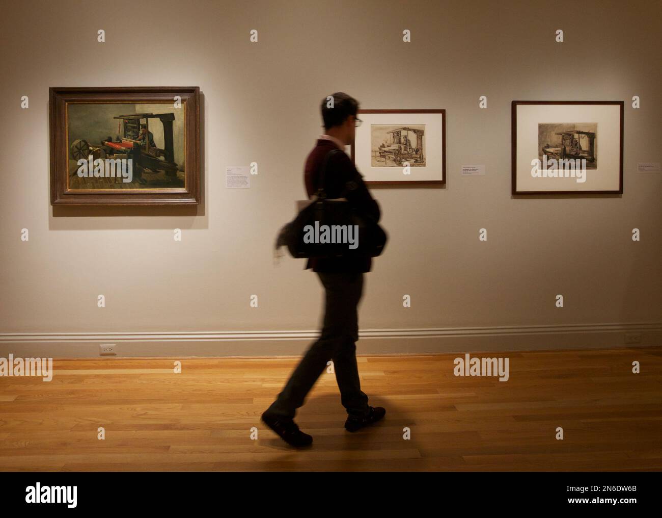 A visitor passes by Vincent van Gogh's "Weaver," (Right) on display at ...