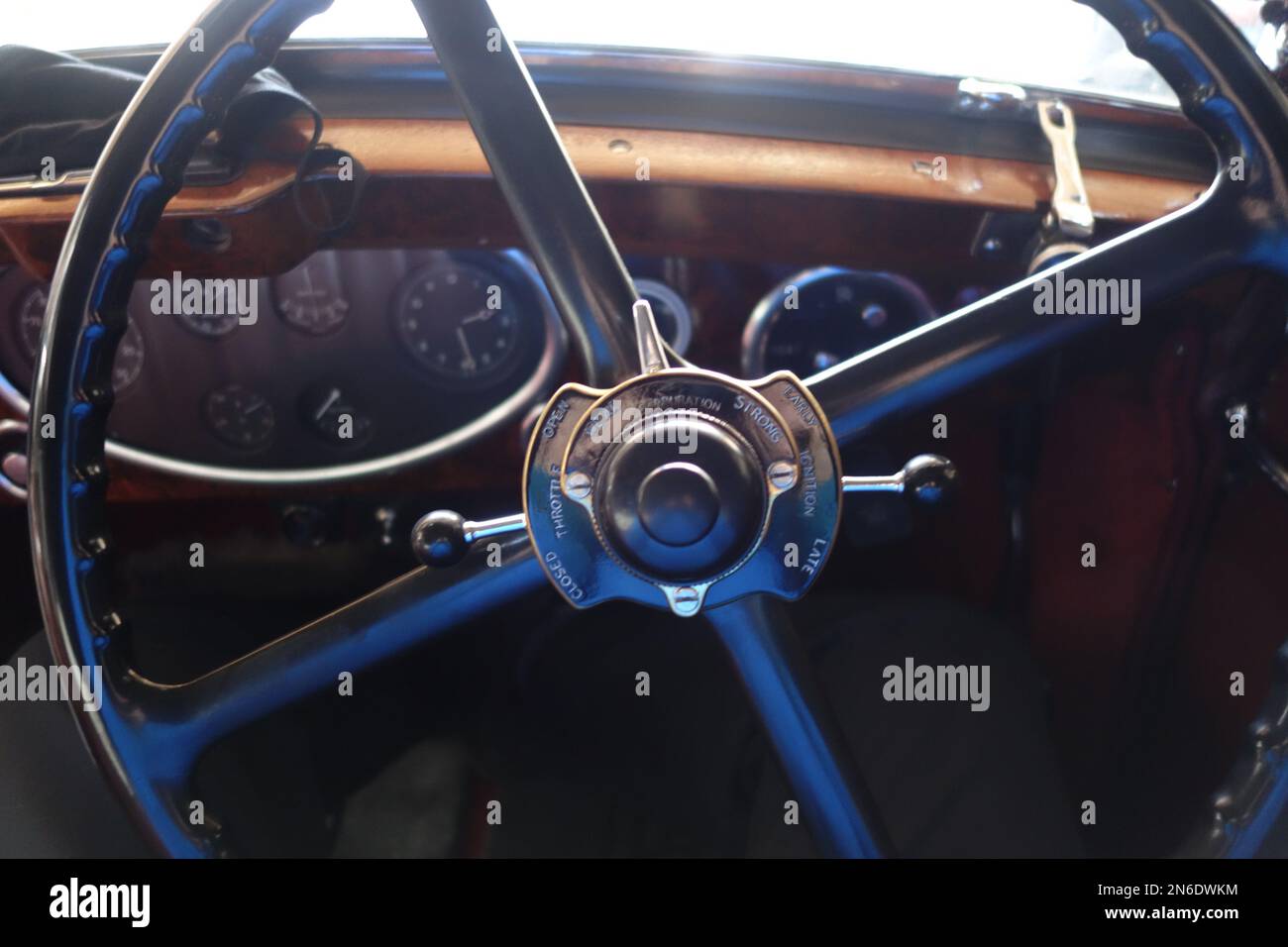 A closeup shot of the steering wheel of an old vintage car and the ...