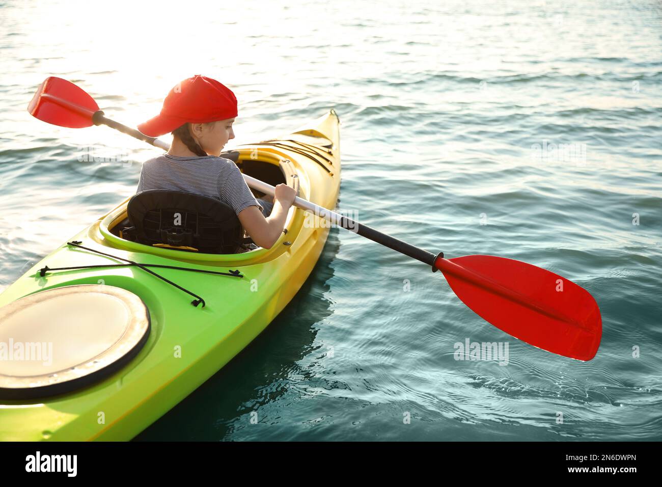 Little girl kayaking on river, back view. Summer camp activity Stock ...