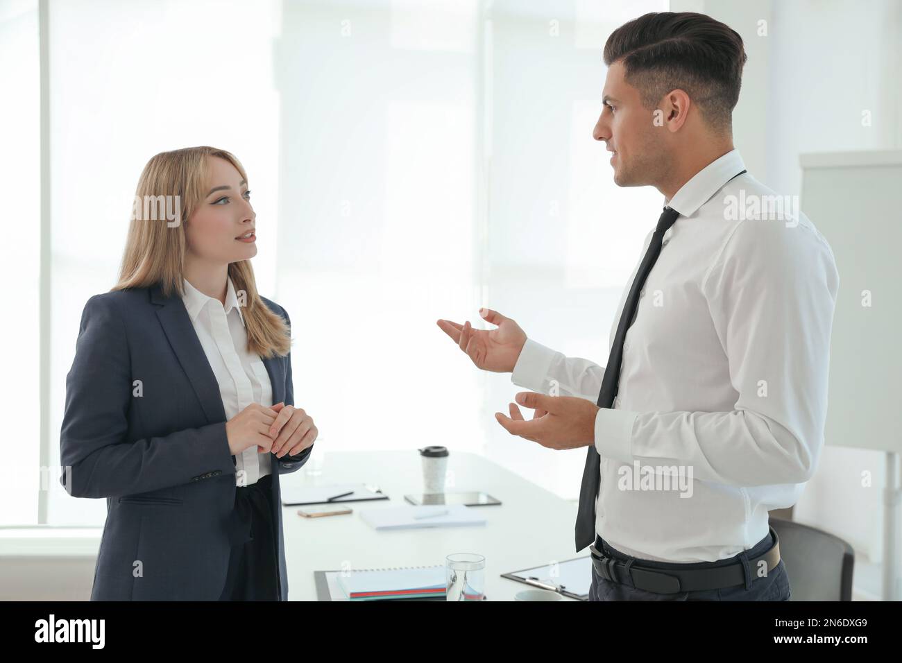 Office employees talking at workplace during break Stock Photo - Alamy
