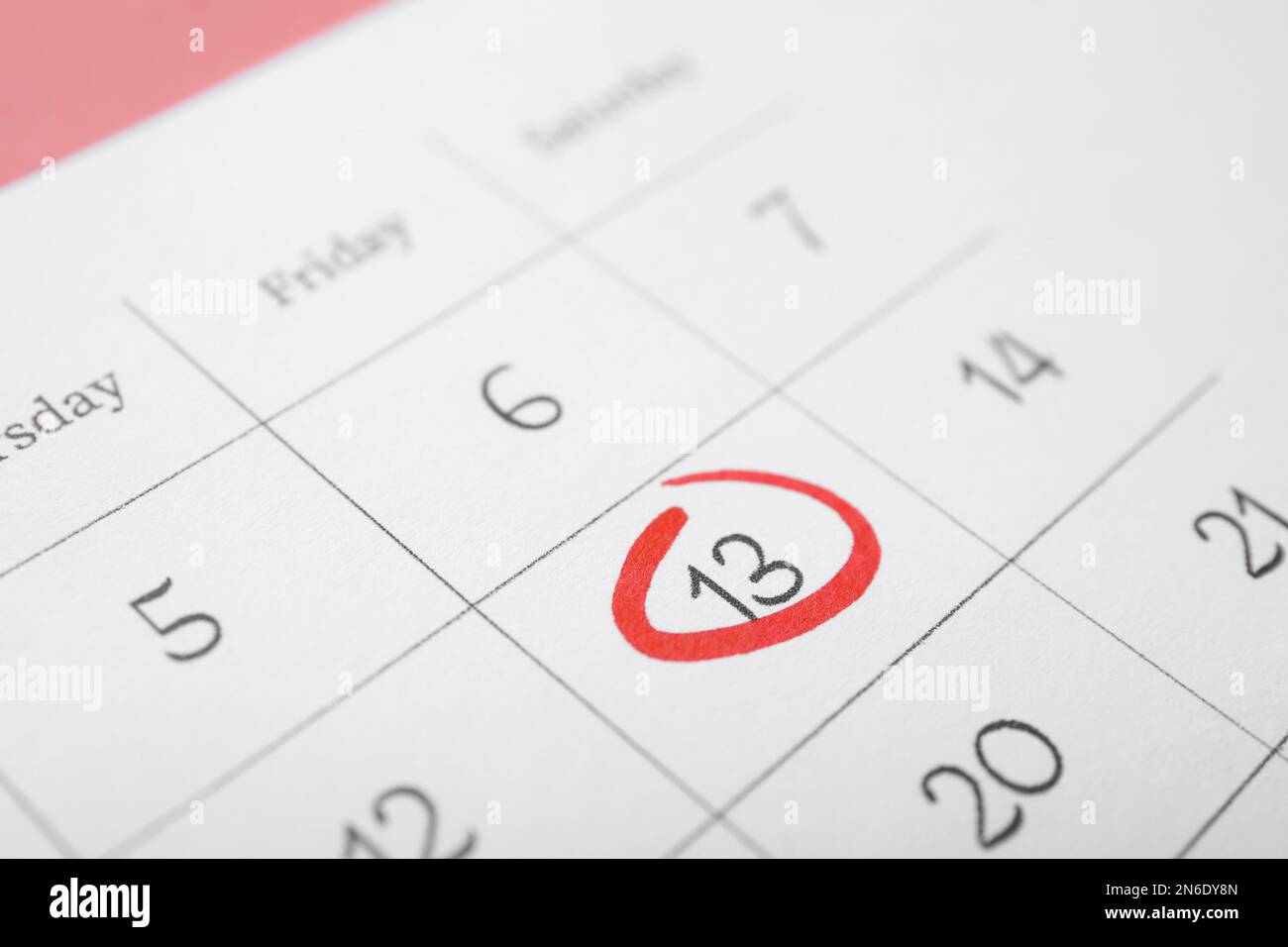 Calendar page with marked Friday 13, closeup. Bad luck superstition ...