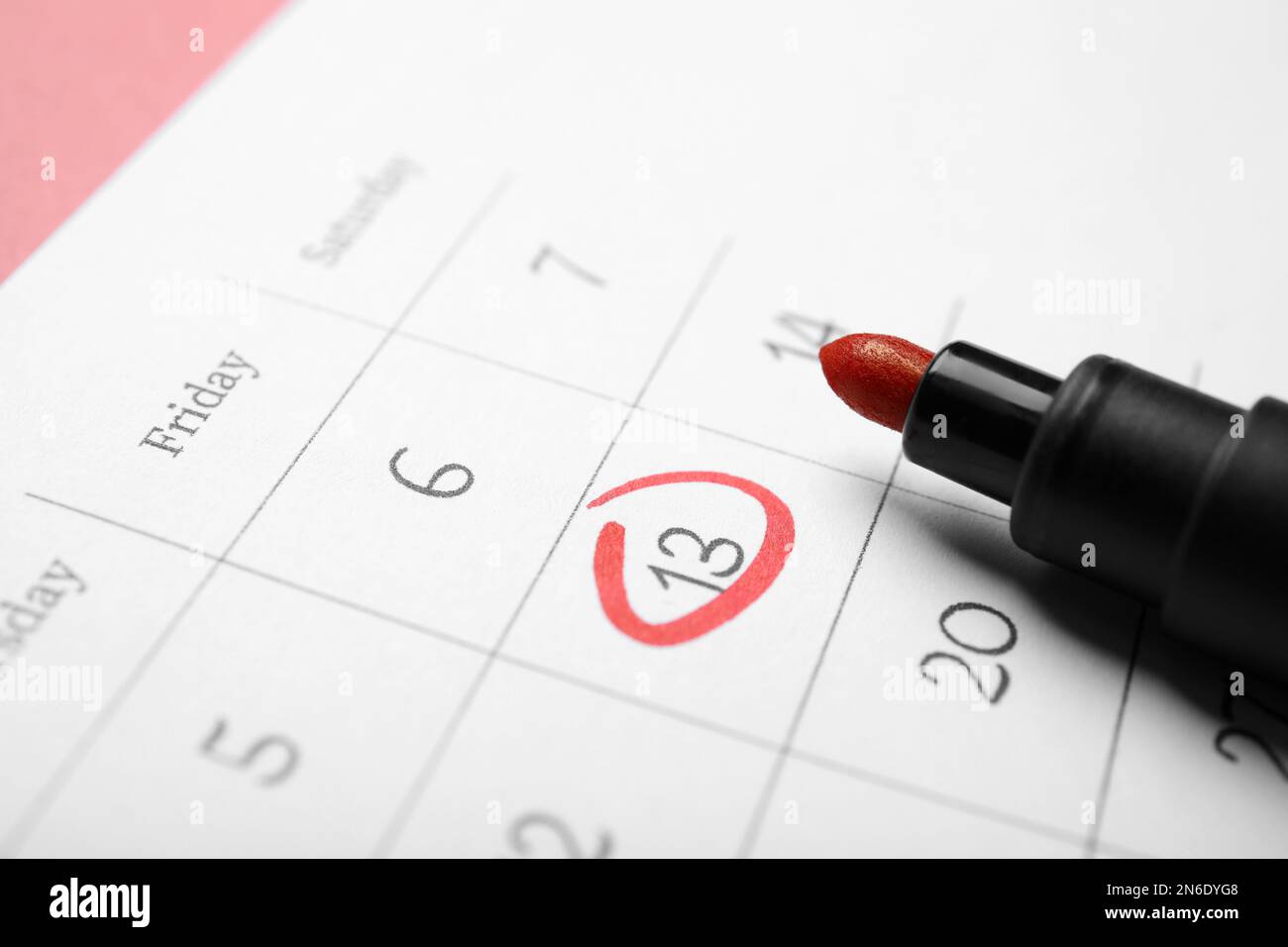 Calendar page with marked Friday 13, closeup. Bad luck superstition ...