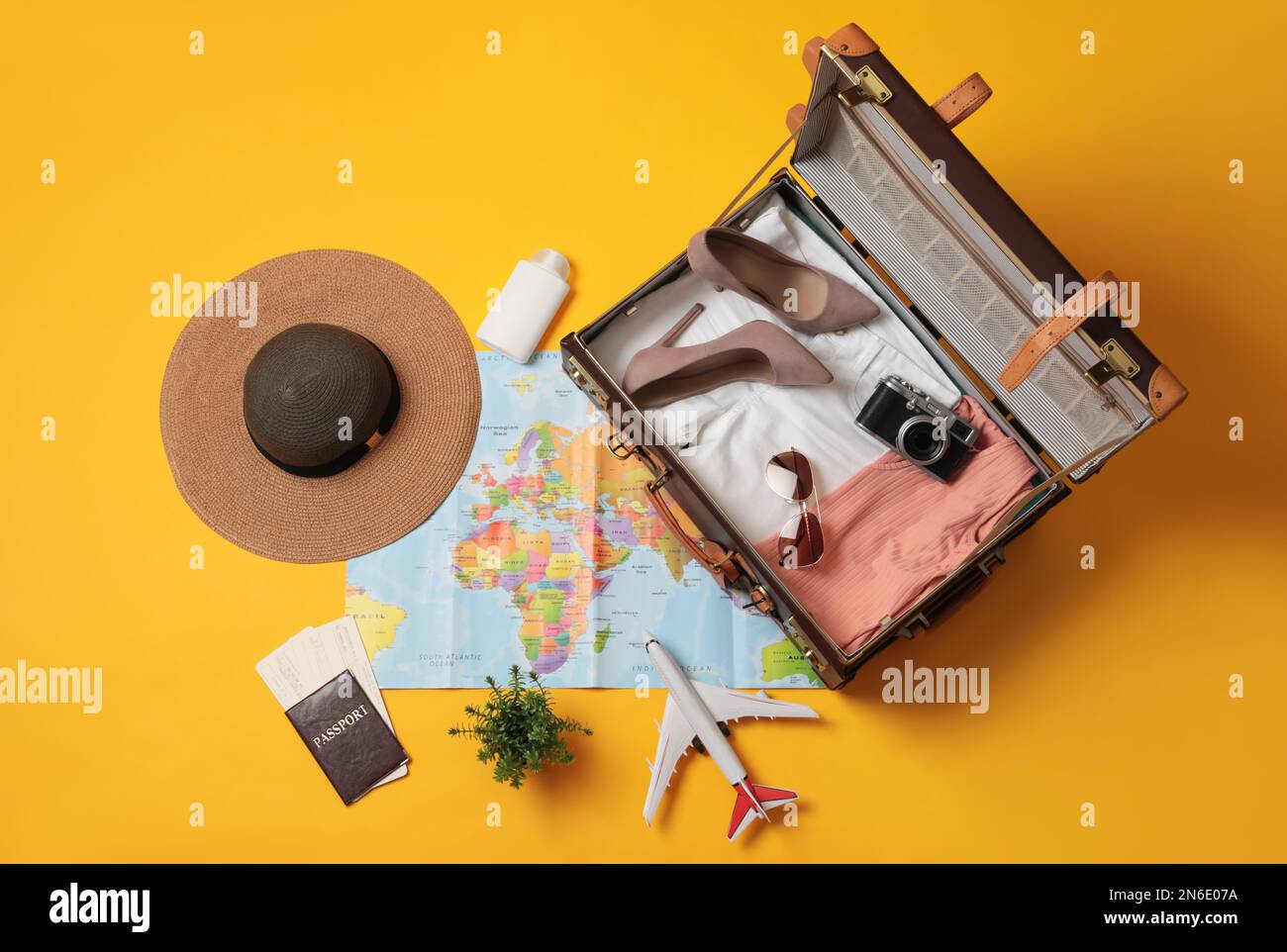 Flat lay composition with packed suitcase and travel accessories on ...
