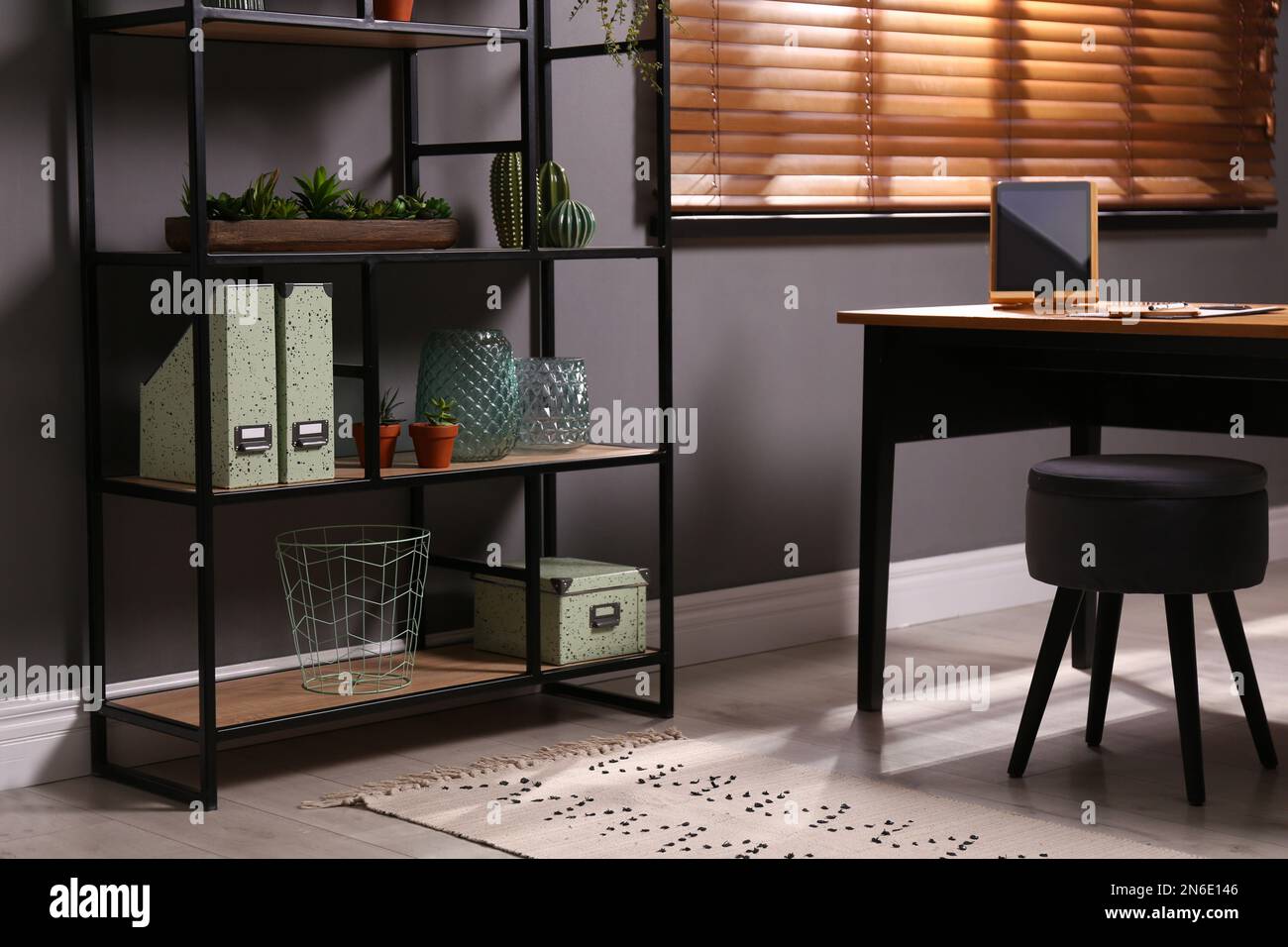 Stylish room with shelving and table. Interior design Stock Photo - Alamy