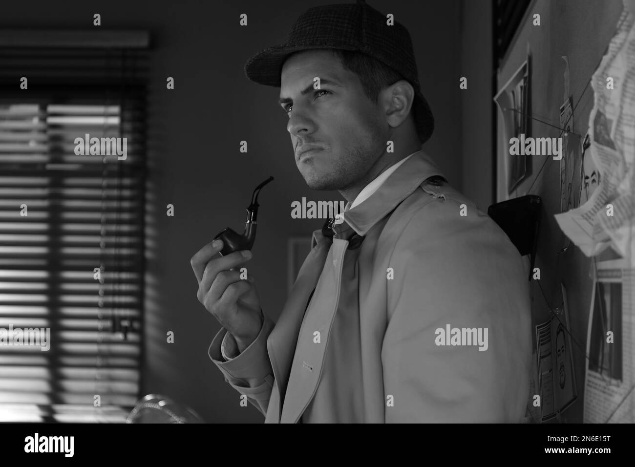 Old fashioned detective with smoking pipe near investigation board in ...
