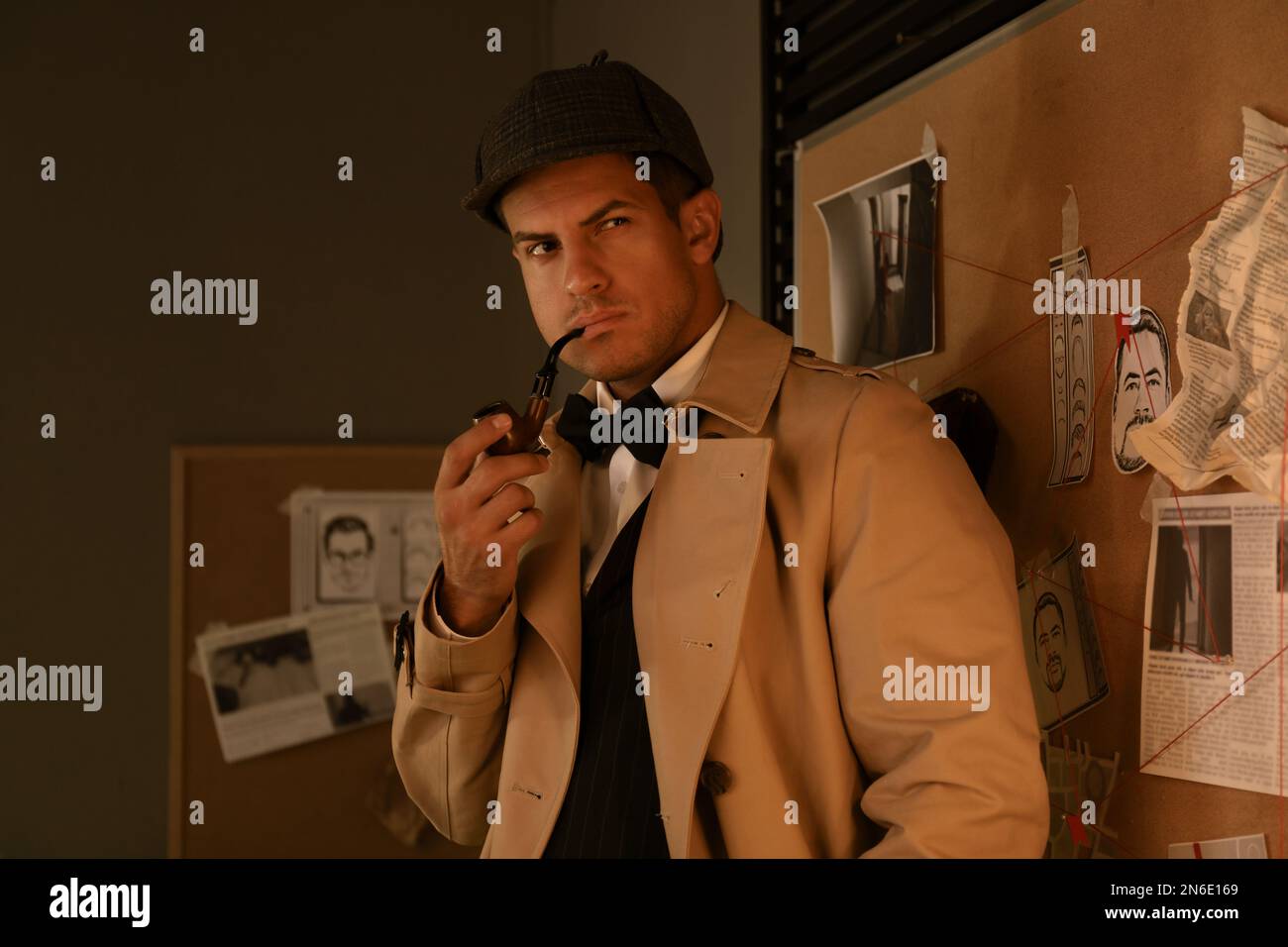 Old fashioned detective with smoking pipe near investigation board in ...