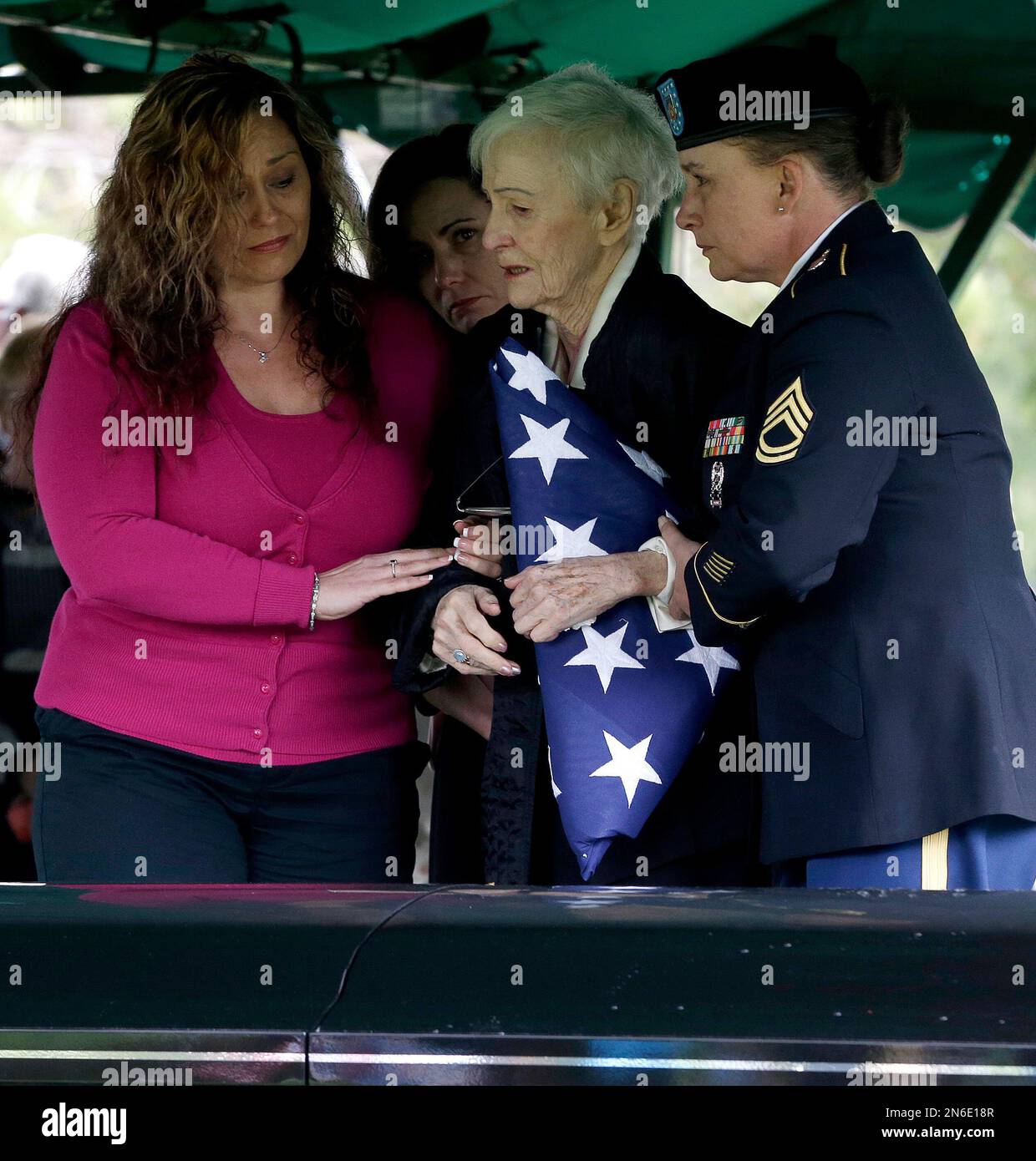 Genevieve Doocey, center right, is comforted by her granddaughters, from left, Laura Wyton ...