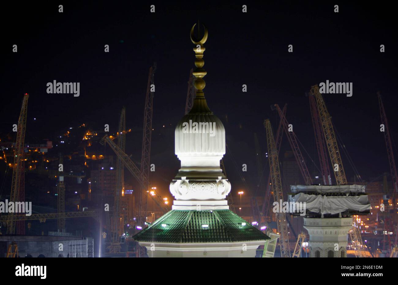 Cranes at the site of an expansion to the Grand Mosque look over its ...