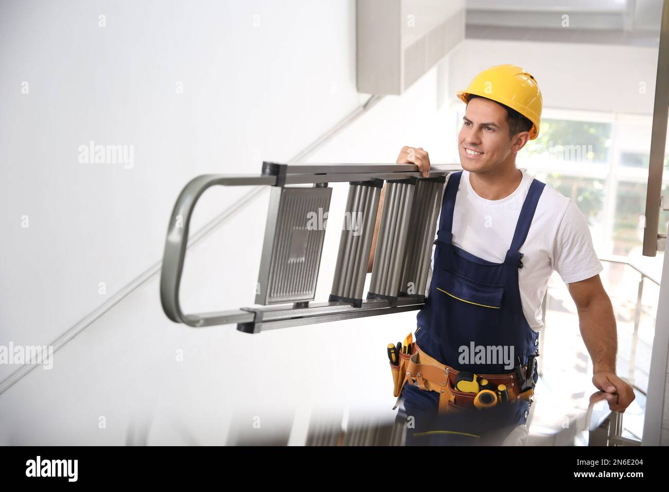 Male worker carrying stepladder hi-res stock photography and images - Alamy