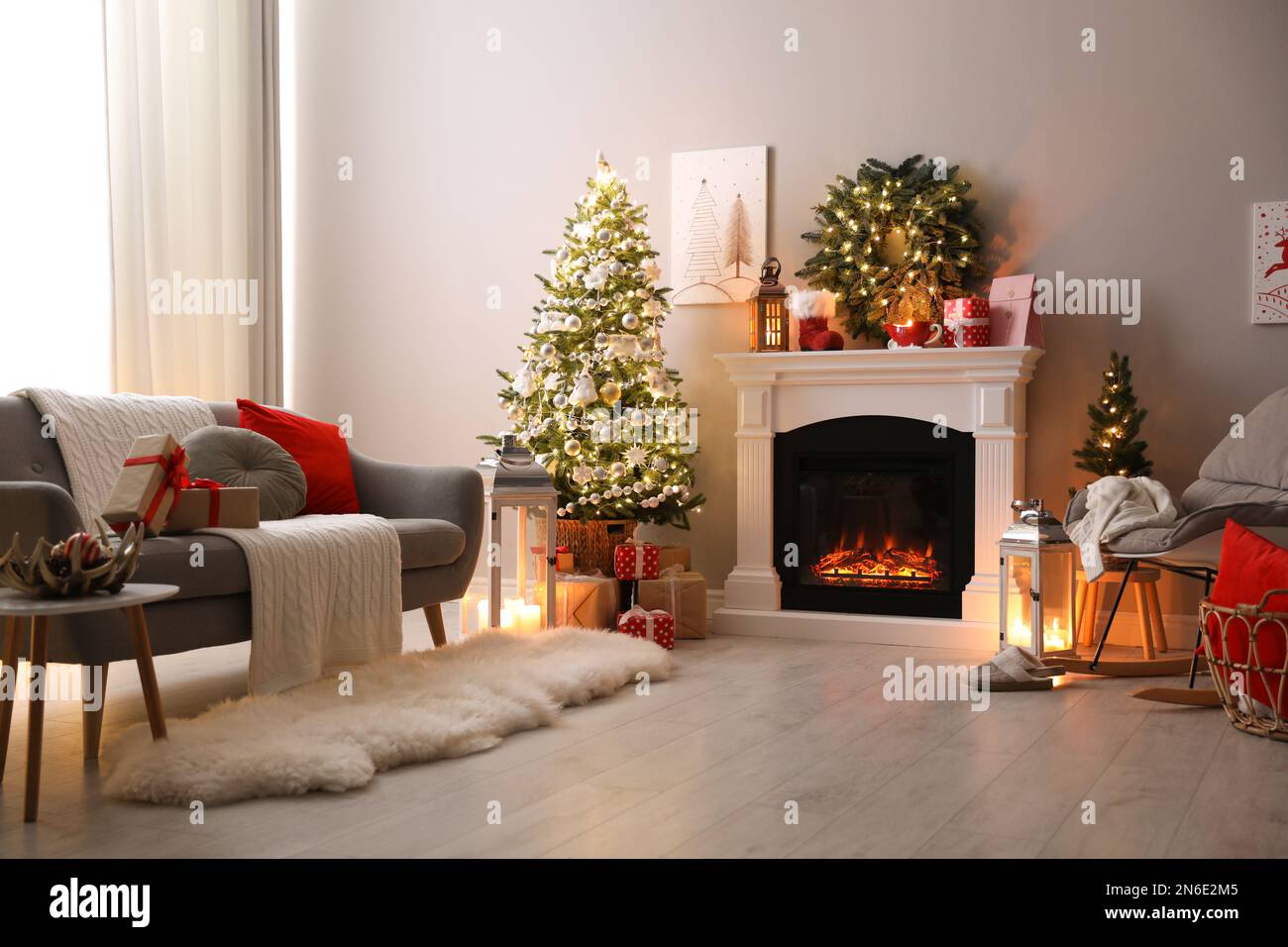 Stylish living room interior with beautiful fireplace, Christmas tree ...