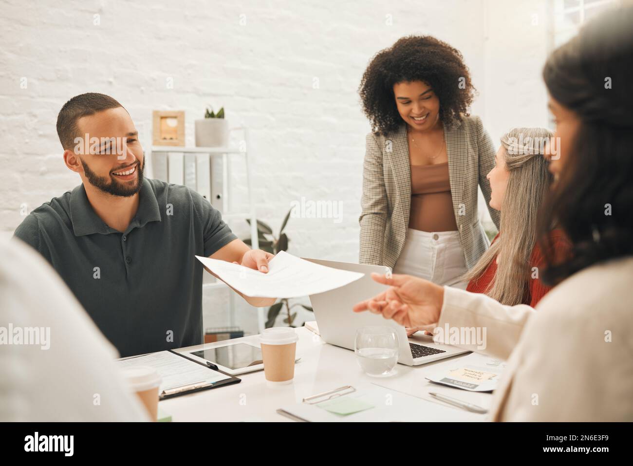 Businessman giving a colleague a document. Architect giving his ...