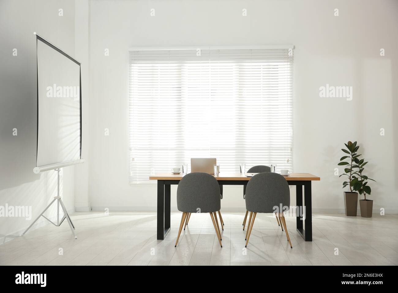 Conference room interior with wooden table and video projection screen ...
