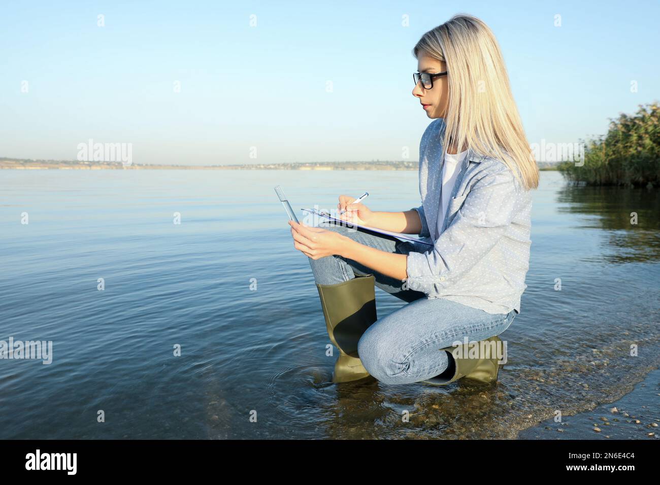 Scientist with clipboard and sample taken from river Stock Photo - Alamy