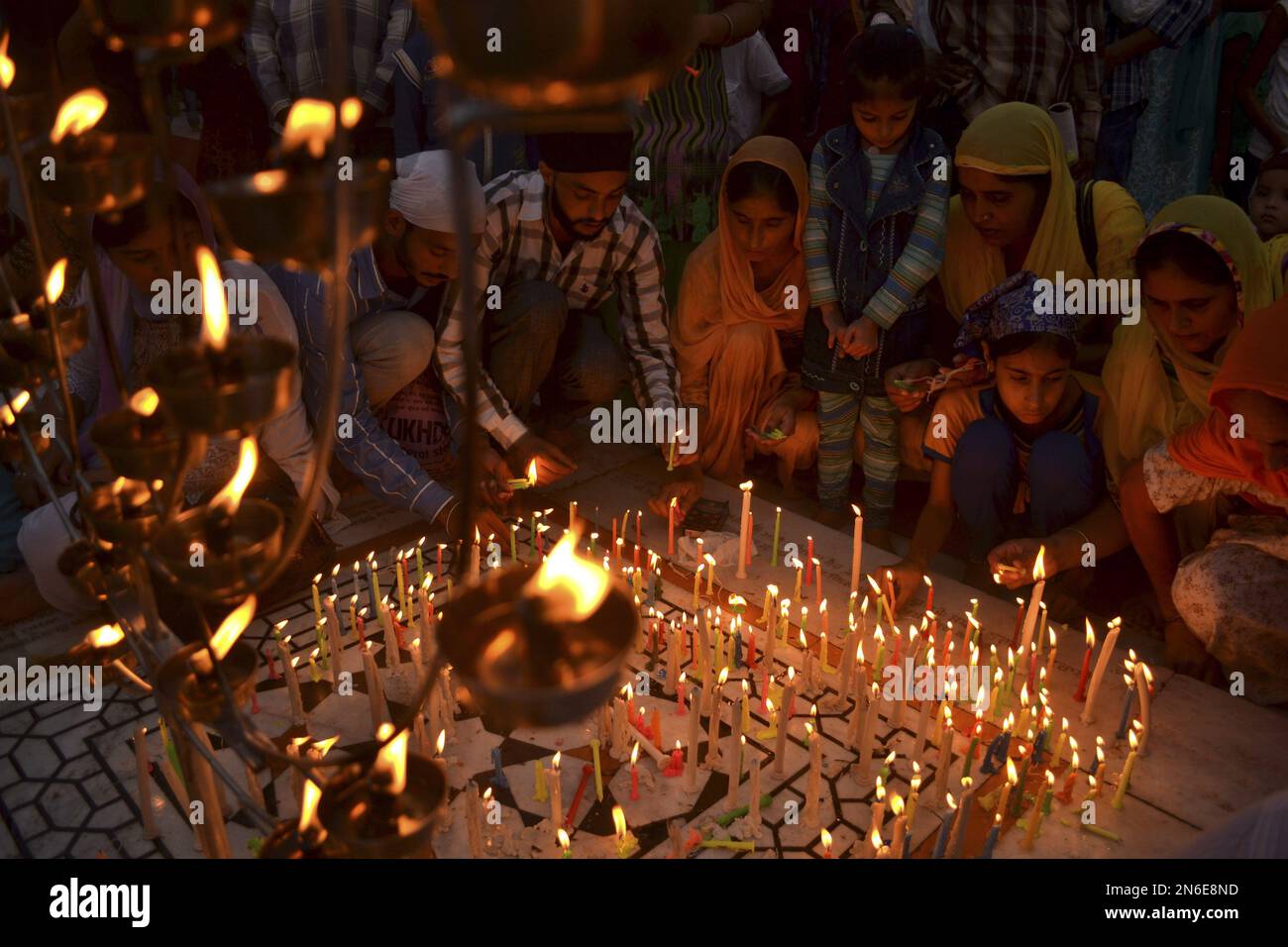 Sikh devotees light candles and lamps at the Golden Temple, Sikh's ...