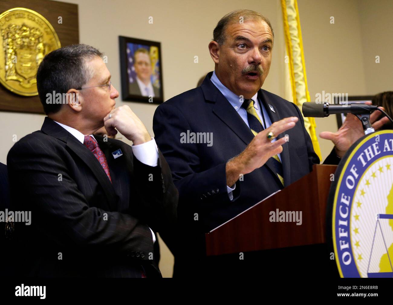 New Jersey State Parole Board Chairman James Plousis, right, speaks as ...