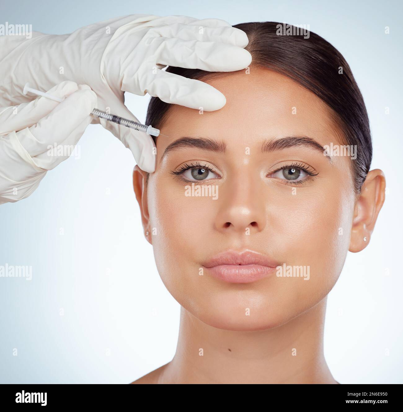 Closeup portrait of woman getting facial fillers or botox. Young ...