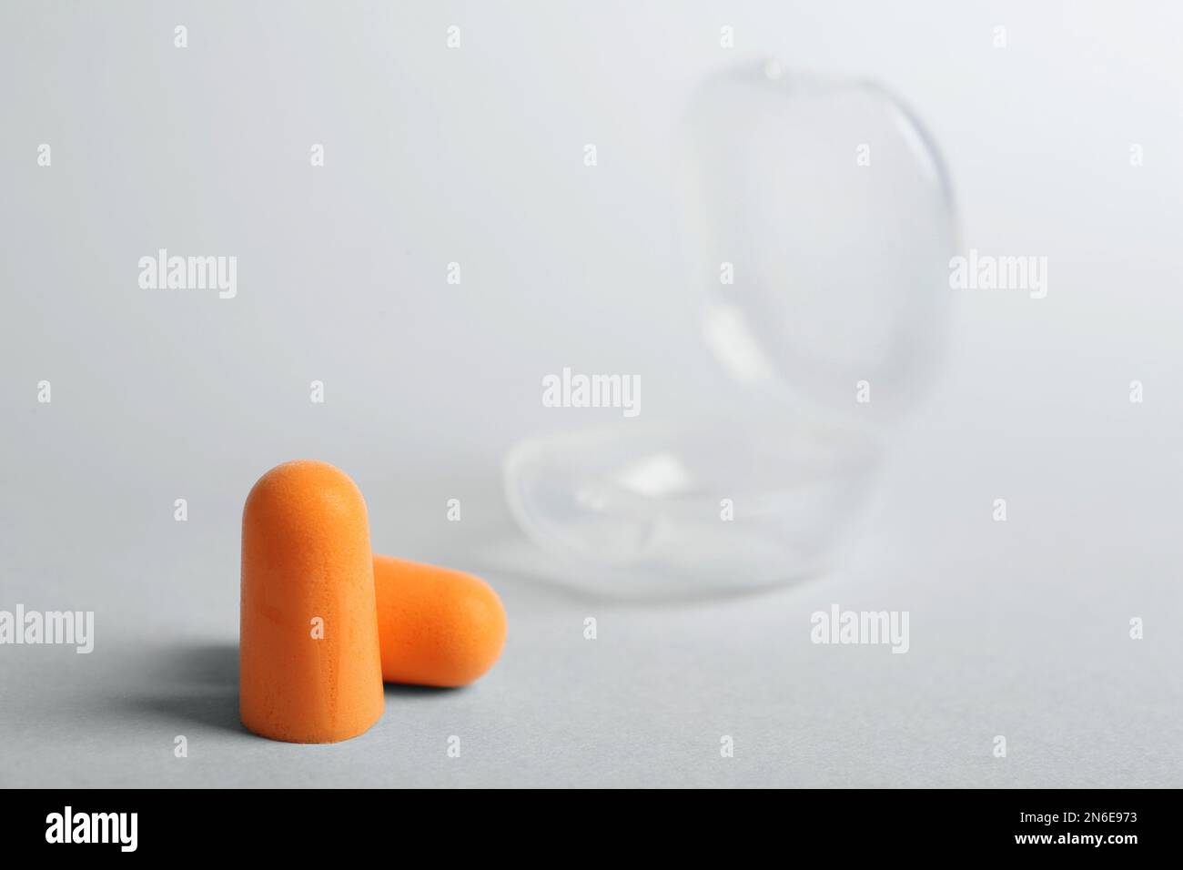 Pair of orange ear plugs on white background. Space for text Stock ...