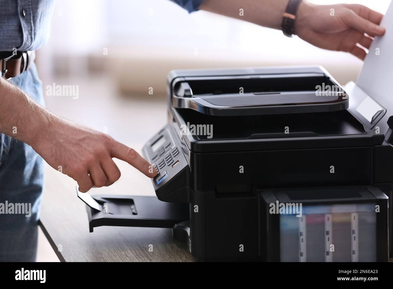 Employee using modern printer in office, closeup Stock Photo - Alamy