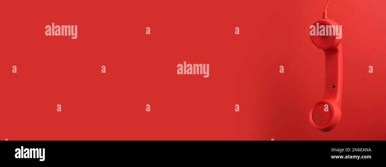 Hotline service. Telephone receiver and space for text on red ...