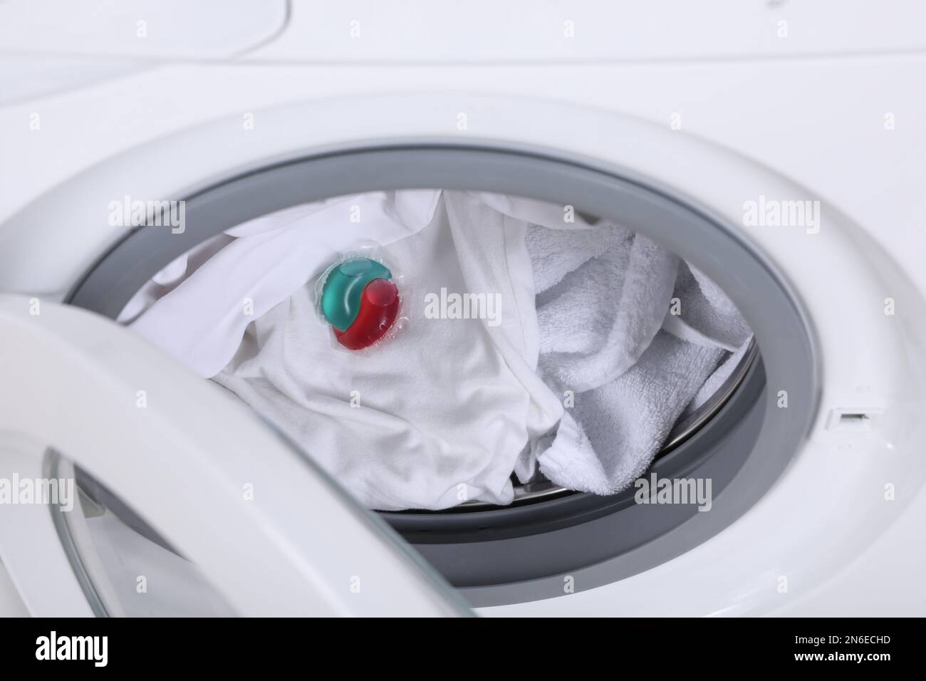 Laundry detergent capsule in washing machine drum, closeup view Stock ...