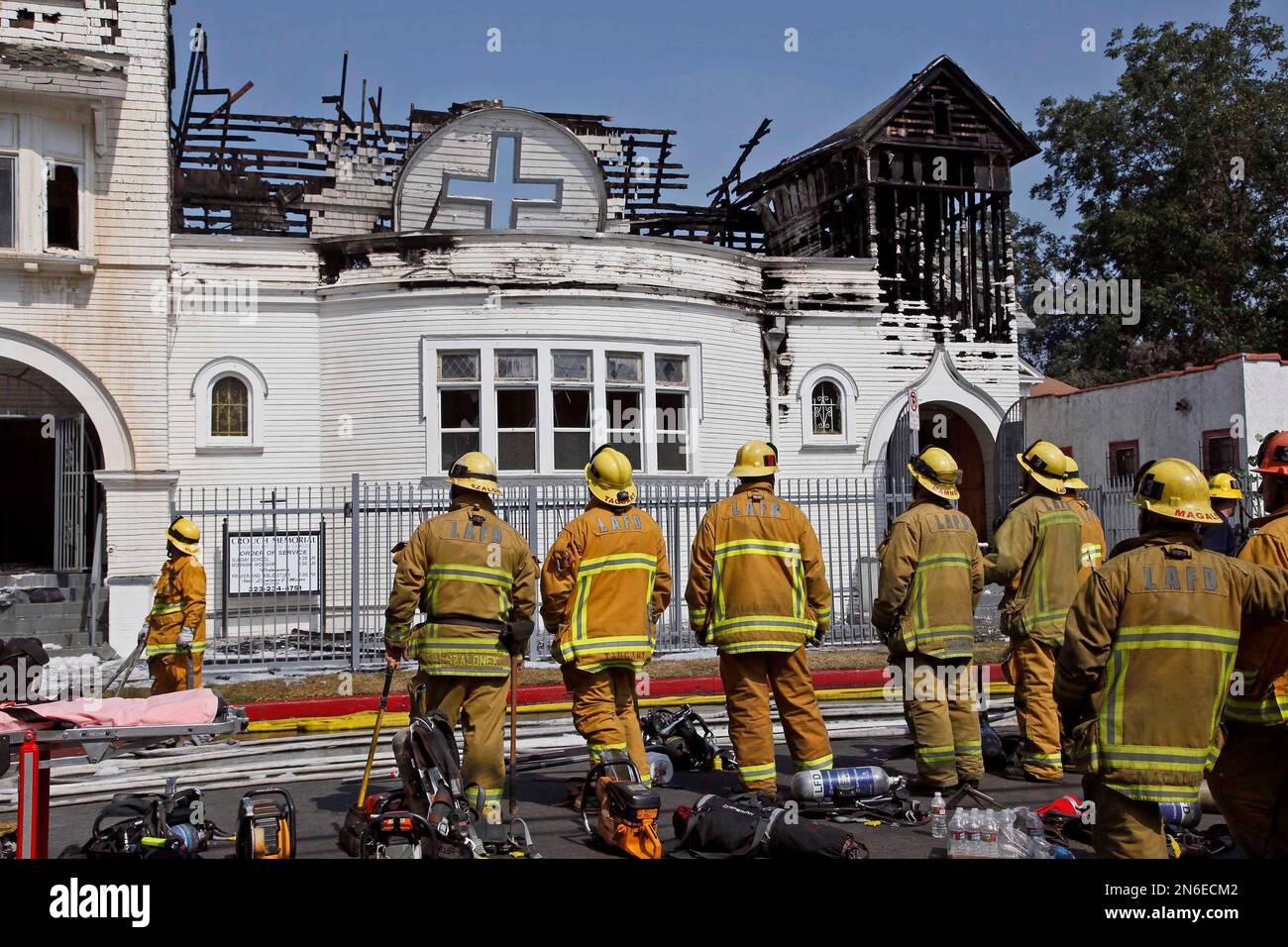 Los Angeles city firefighters spray water on the century-old Crouch ...