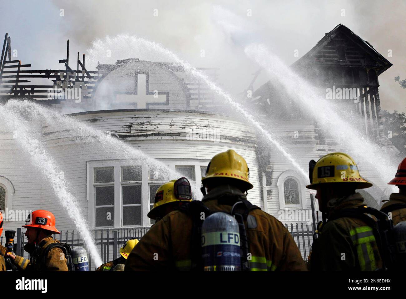 Los Angeles city firefighters spray water on the century-old Crouch ...